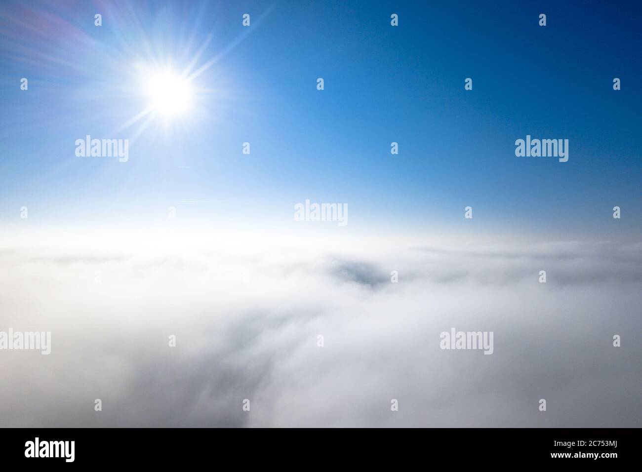 Aerial view of mist layer from above looking like sun shining above ...