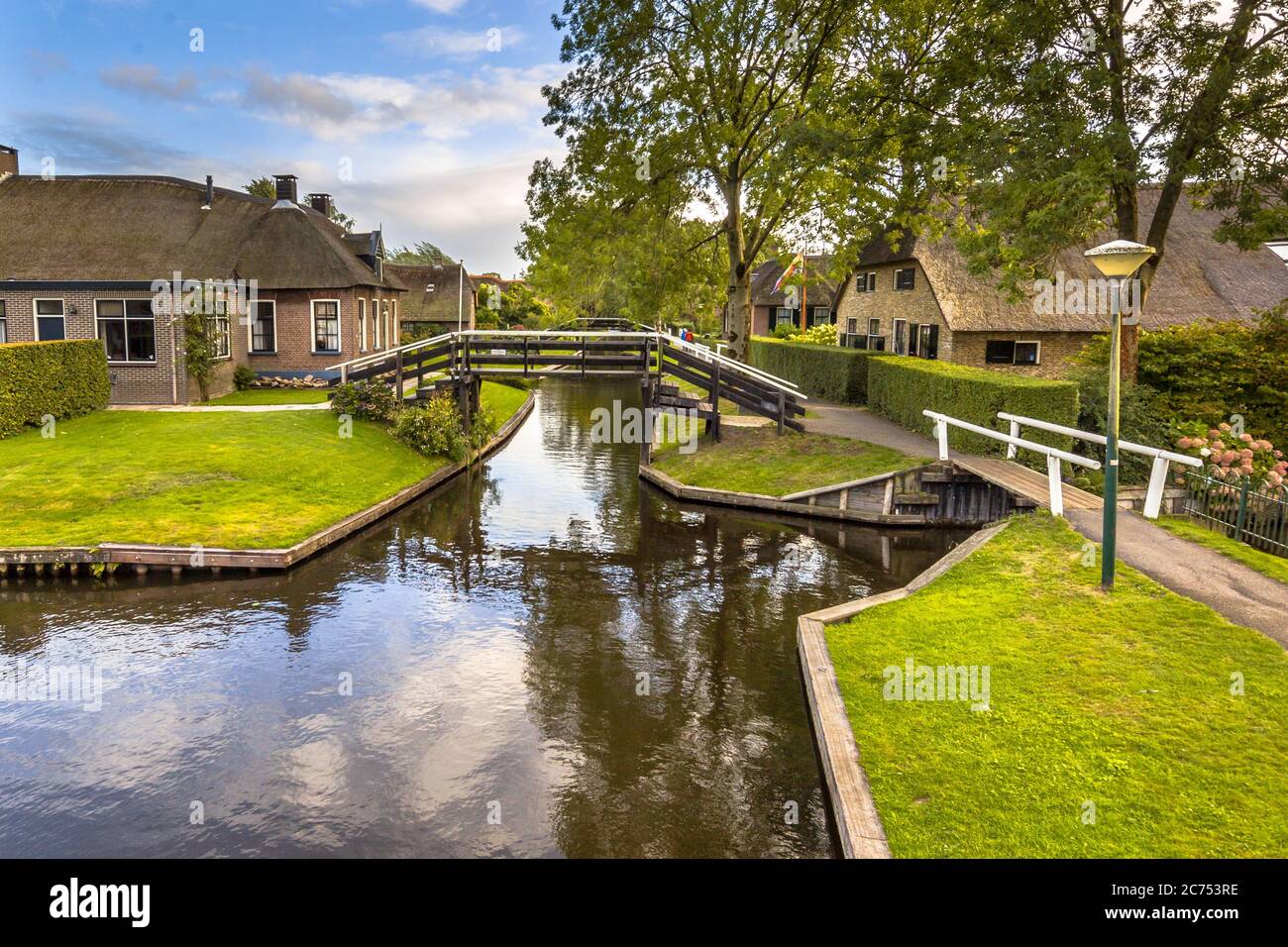 Landscape view of famous Giethoorn village with canals and rustic thatched roof houses in farm ...