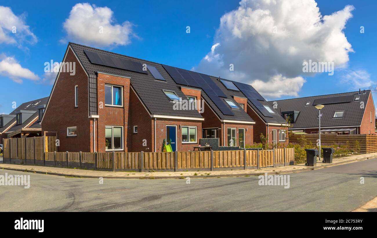 Street landscape with modern houses and flowers in a dutch town, The ...