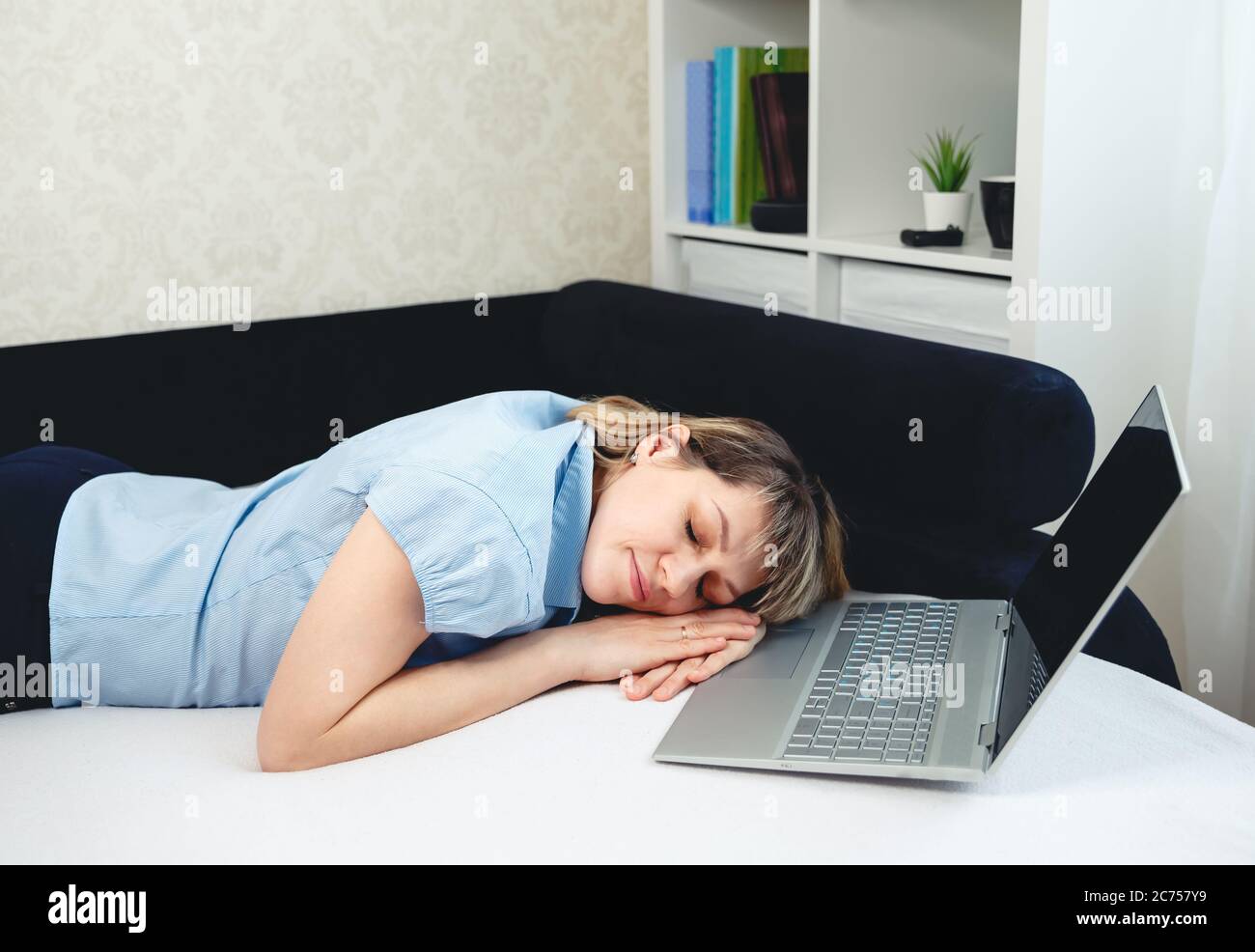 Tired female sleeping. Sleepy girl working remotely in front of laptop ...