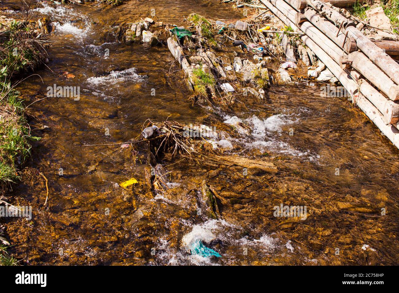 Stream with running water, polluted by plastic garbage Stock Photo - Alamy