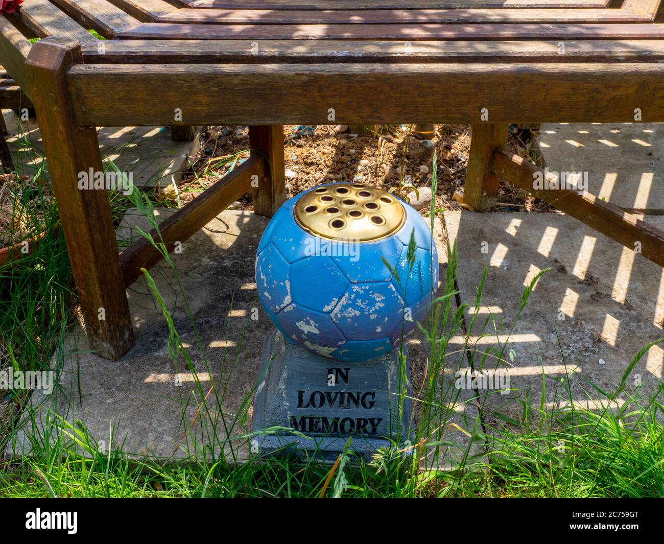 A gravestone with tributes at Cheshunt cemetery, England Stock Photo ...
