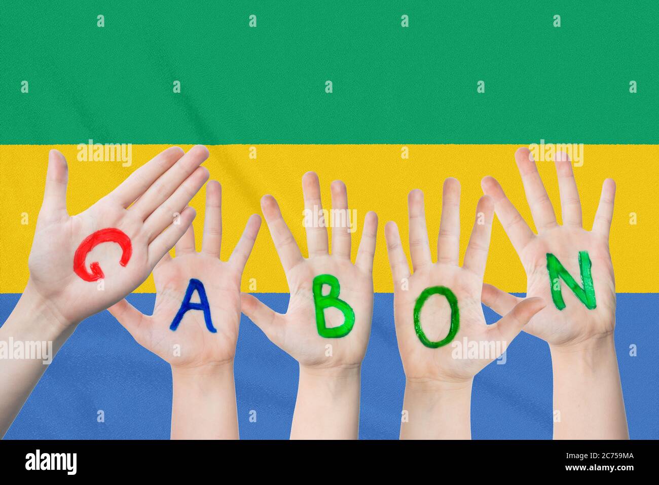 Inscription Gabon on the children's hands against the background of a ...