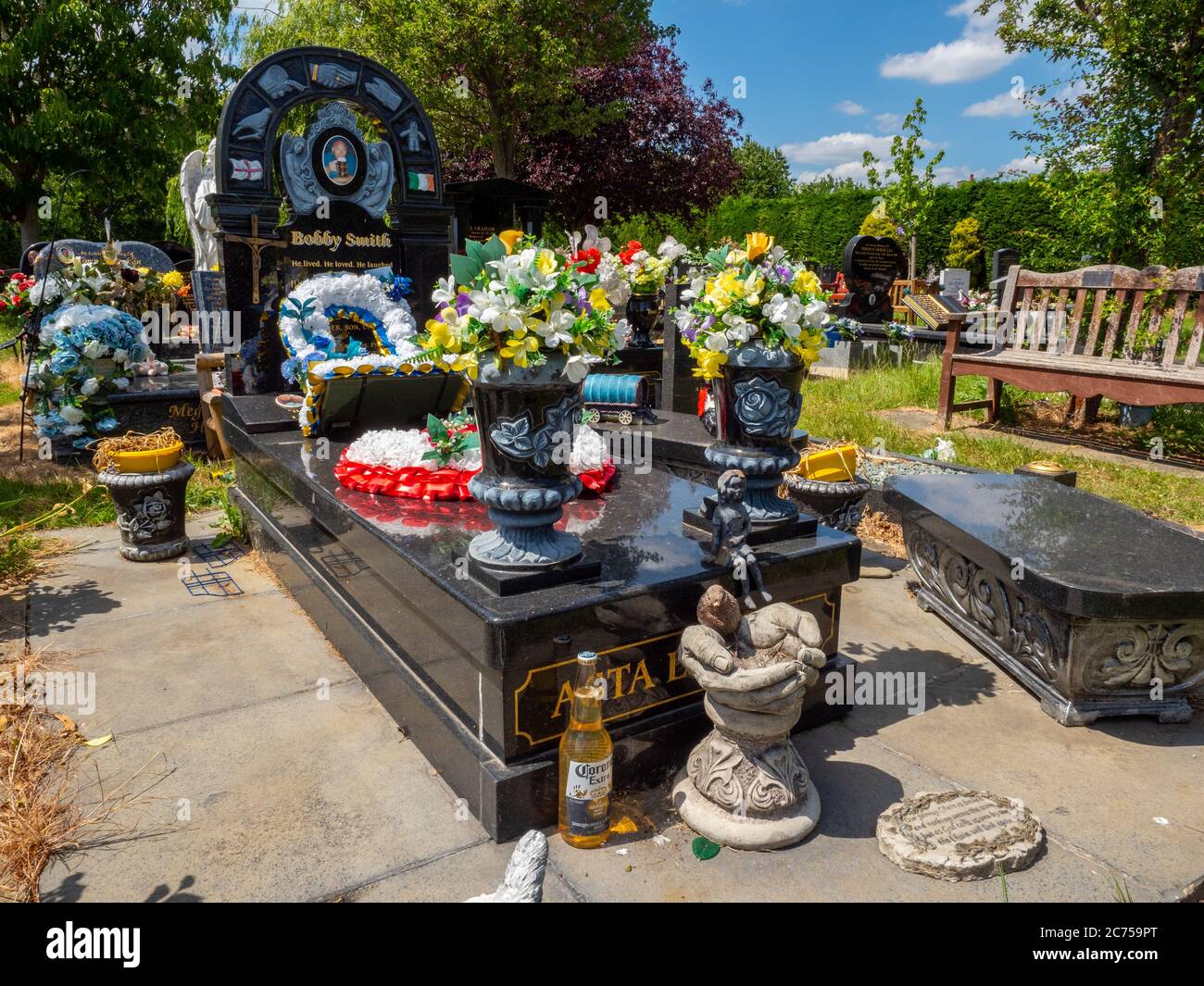 A gravestone with tributes at Cheshunt cemetery, England Stock Photo ...