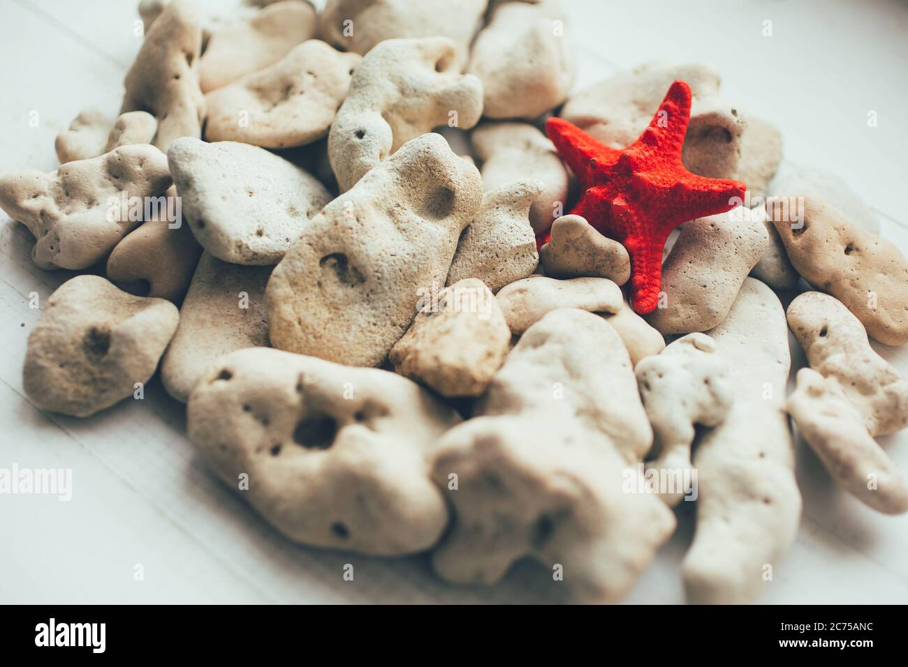Natural pebbles with red starfish on a white background Stock Photo - Alamy