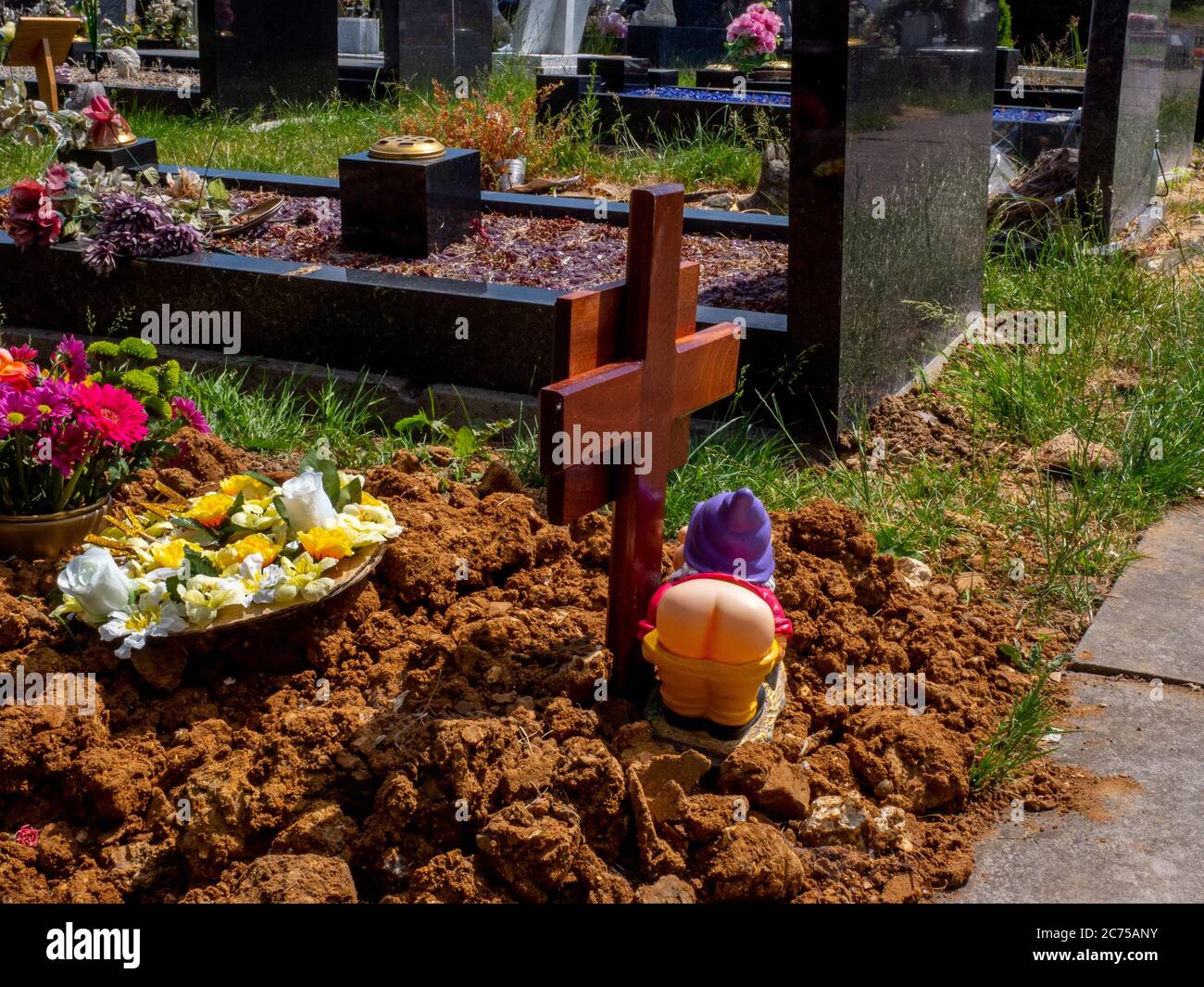 A gravestone with tributes at Cheshunt cemetery, England Stock Photo ...