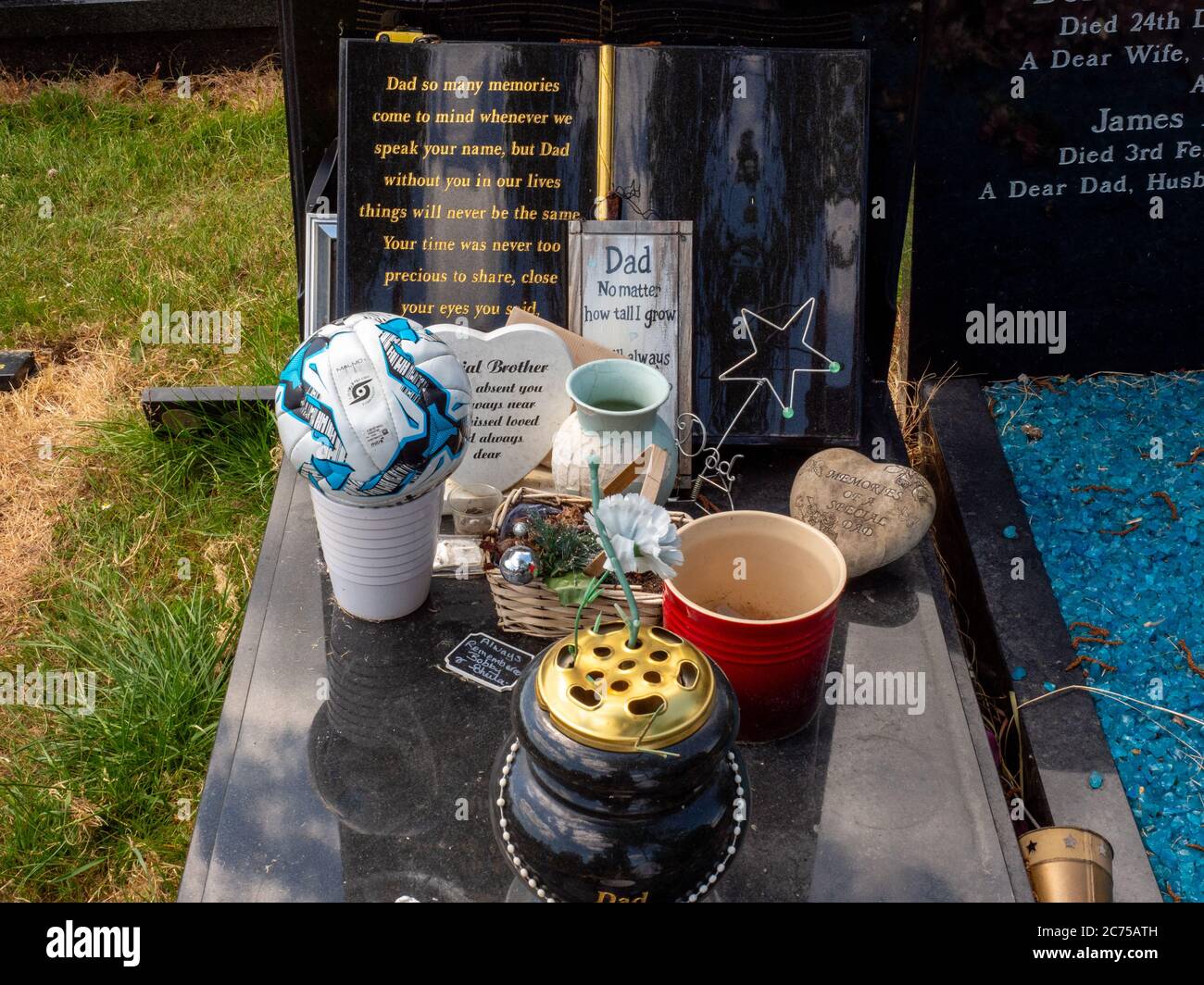 A gravestone with tributes at Cheshunt cemetery, England Stock Photo ...