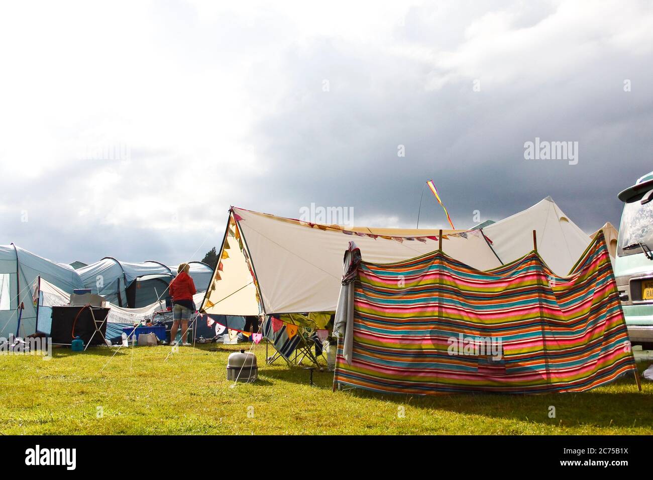 Colourful stripey camping windbreak and awning for shade with bunting ...