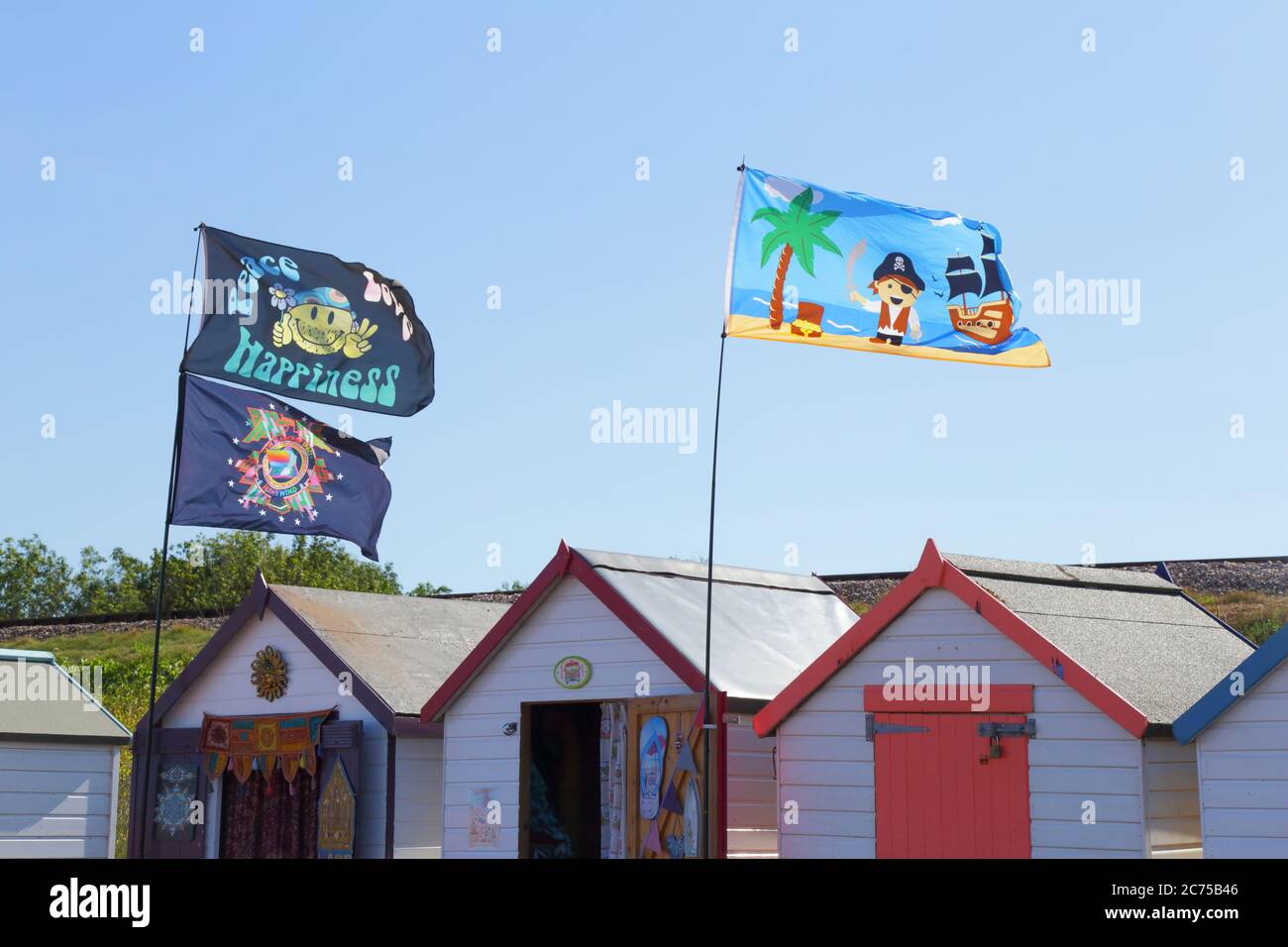 Flags on the beach huts in coastal town of Paignton, Devon Stock Photo ...