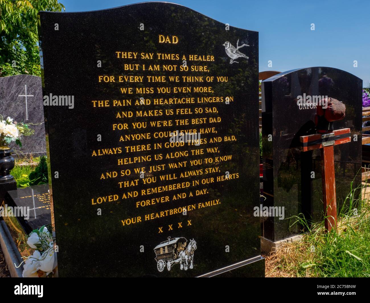 A gravestone with tributes at Cheshunt cemetery, England Stock Photo ...