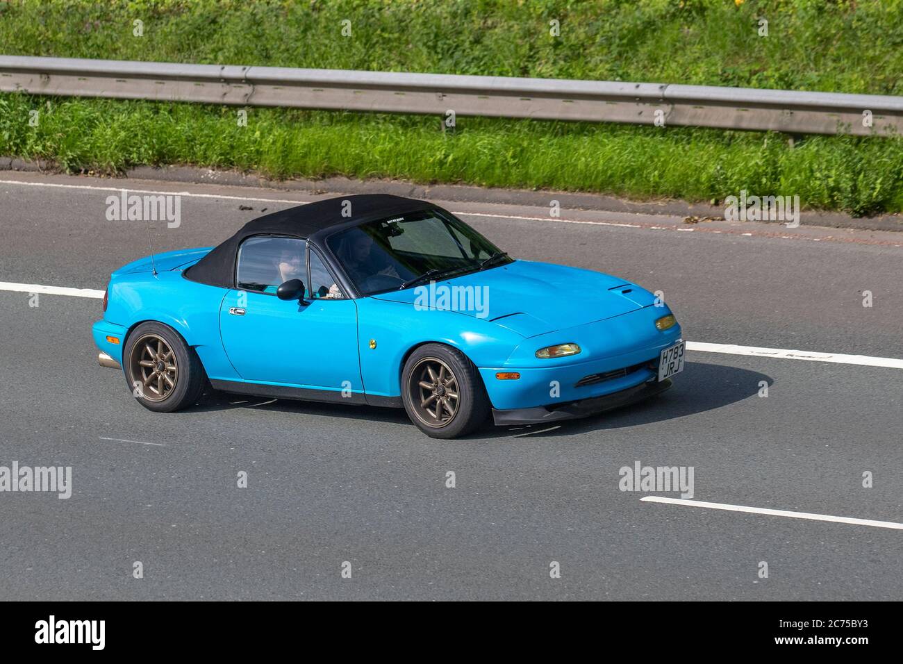 1991 90s nineties blue Mazda Mx-5 cabriolet; Vehicular traffic moving ...