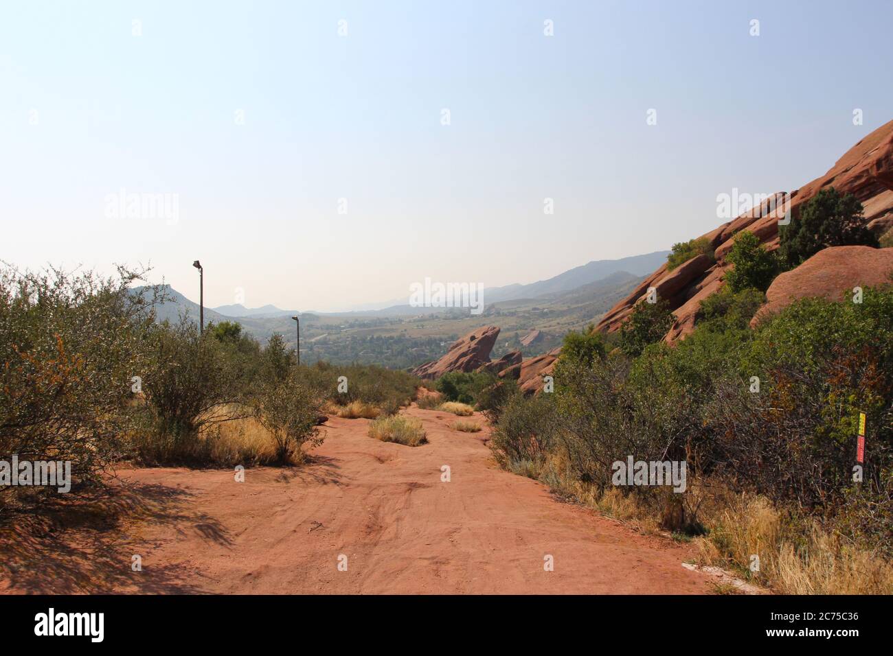 Trading Post Trail lined with large rock formations and vegetation with ...