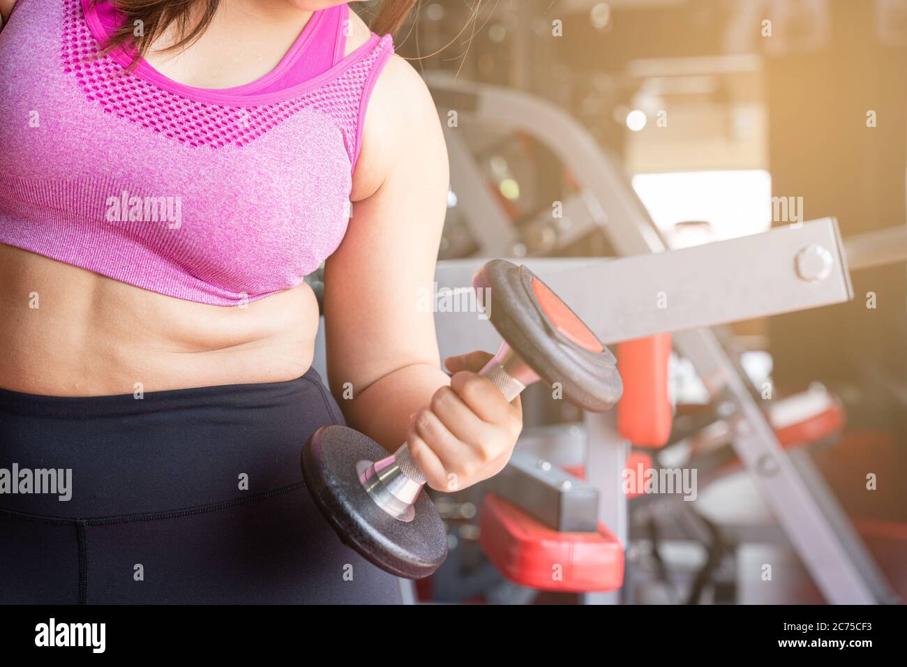 Fat woman holding dumbbell and excessive fat belly, overweight fatty ...