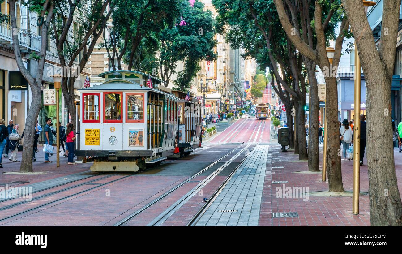 San Francisco, California, USA - August 2019: People riding the cable ...