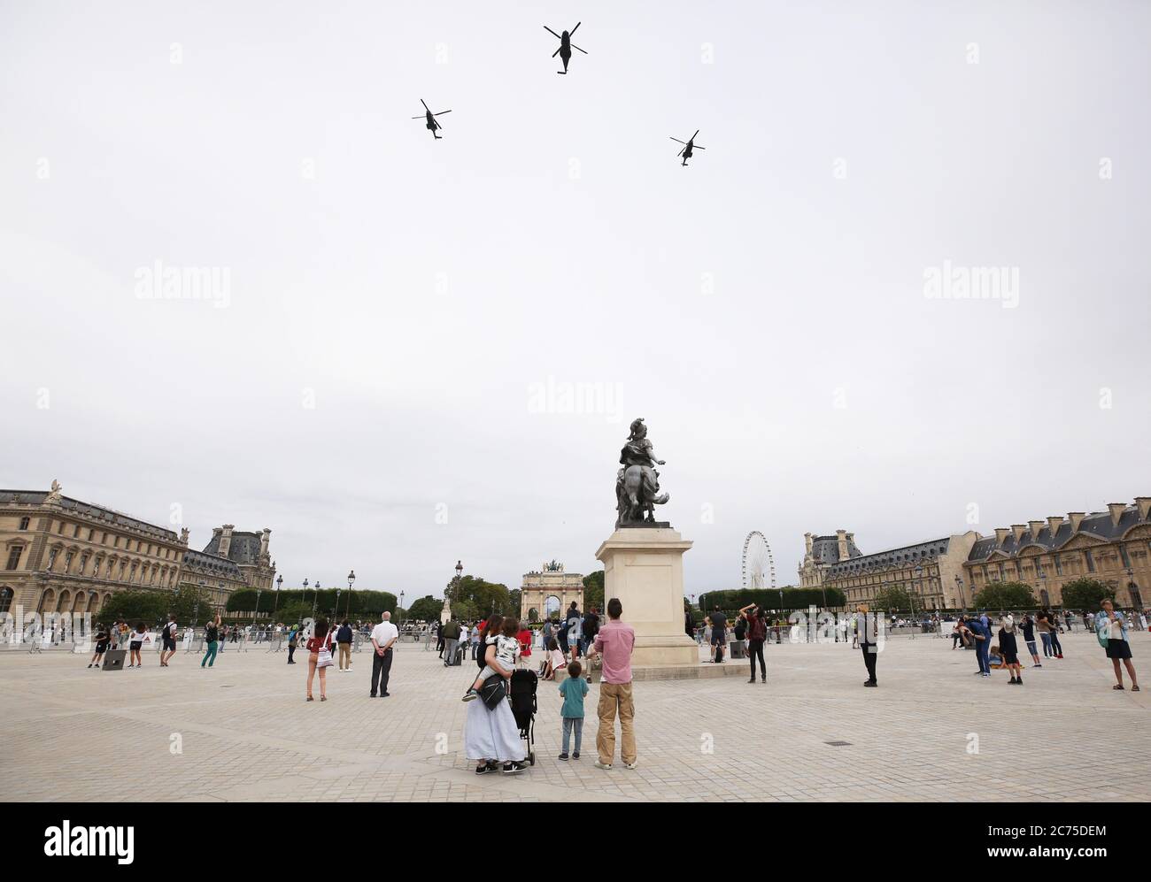 Paris, France. 14th July, 2020. People watch the air show at the Louvre ...