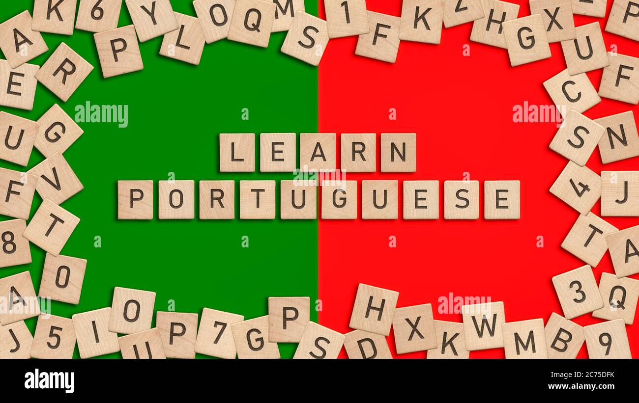Learn Portuguese word written with wooden tiles over Portuguese flag ...