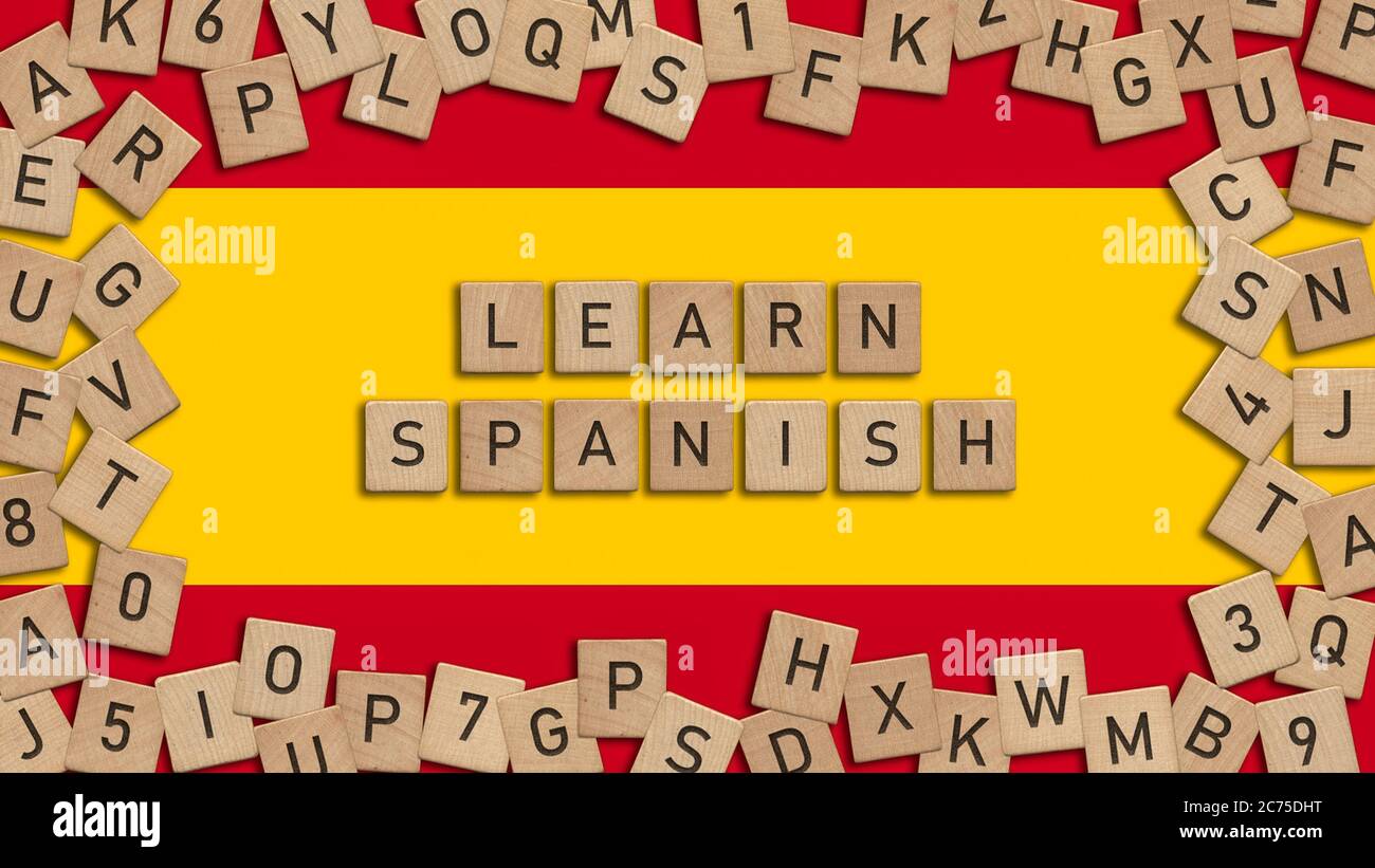 Learn Spanish Word Written With Wooden Tiles Over Spanish Flag This Image Can Be Used For A