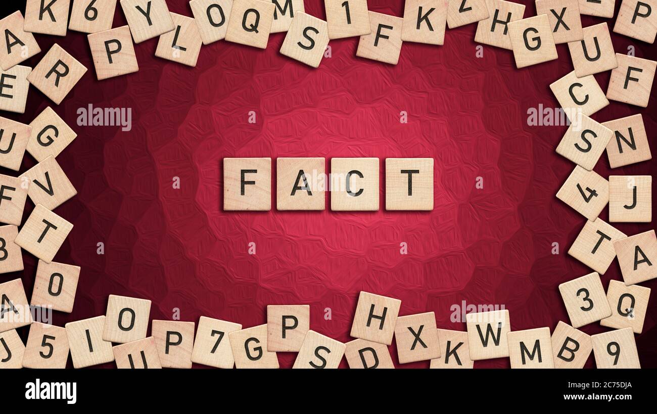 Fact written with wooden tiles over red background. This image can be ...