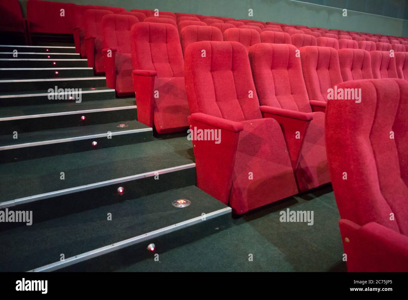 Aisle with rows of red seats in the modern theater Stock Photo - Alamy
