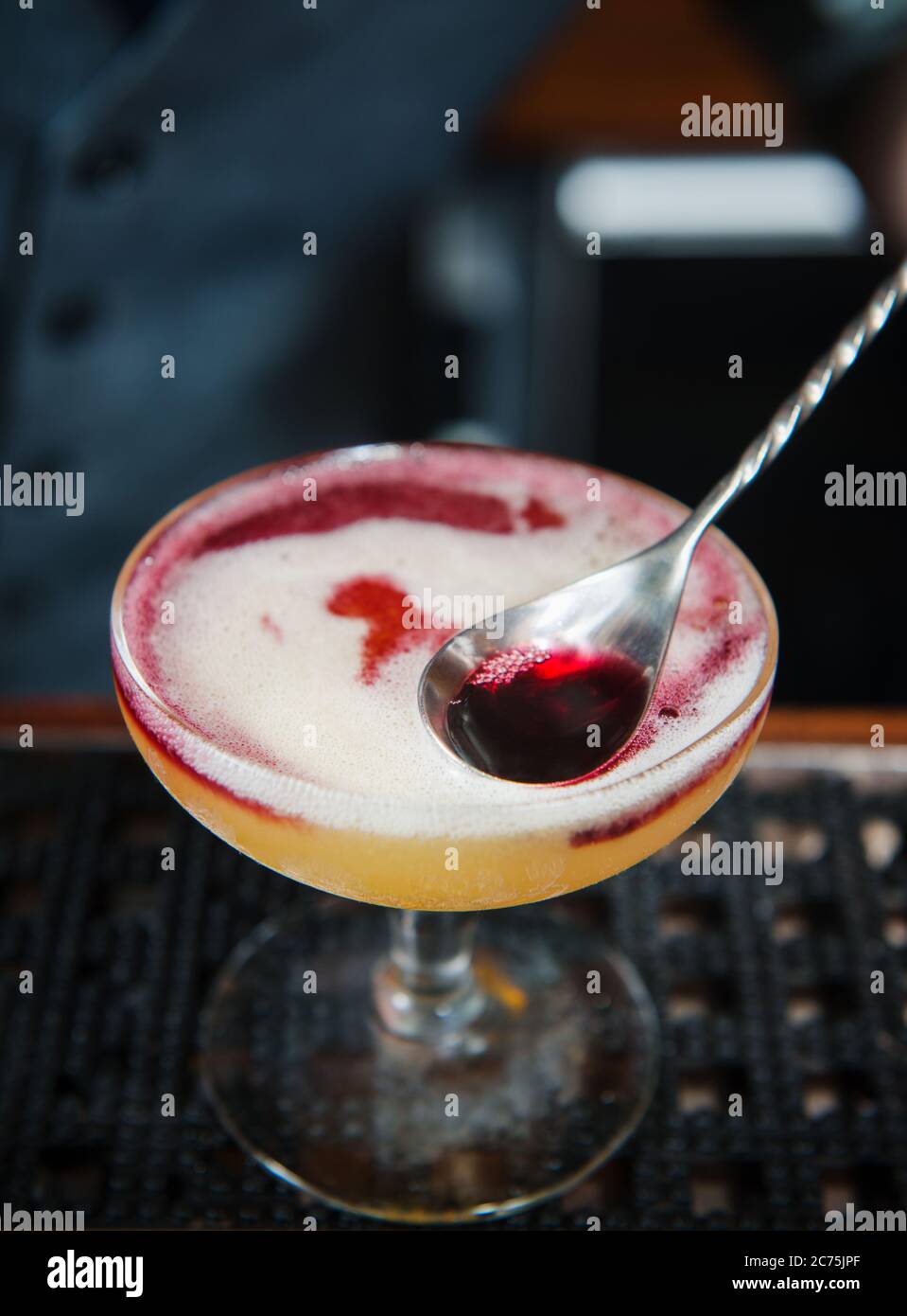 Champagne cocktail with red wine floater being made Stock Photo - Alamy
