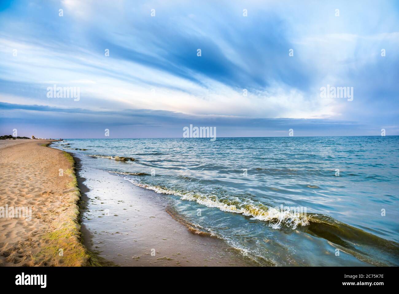 Long tropical beach with yellow sand and blue sea with waves, white ...