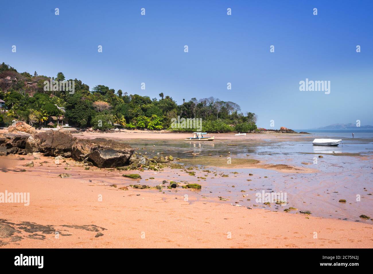 View of the Madagascar Island coastline, lined trees and boats floating ...