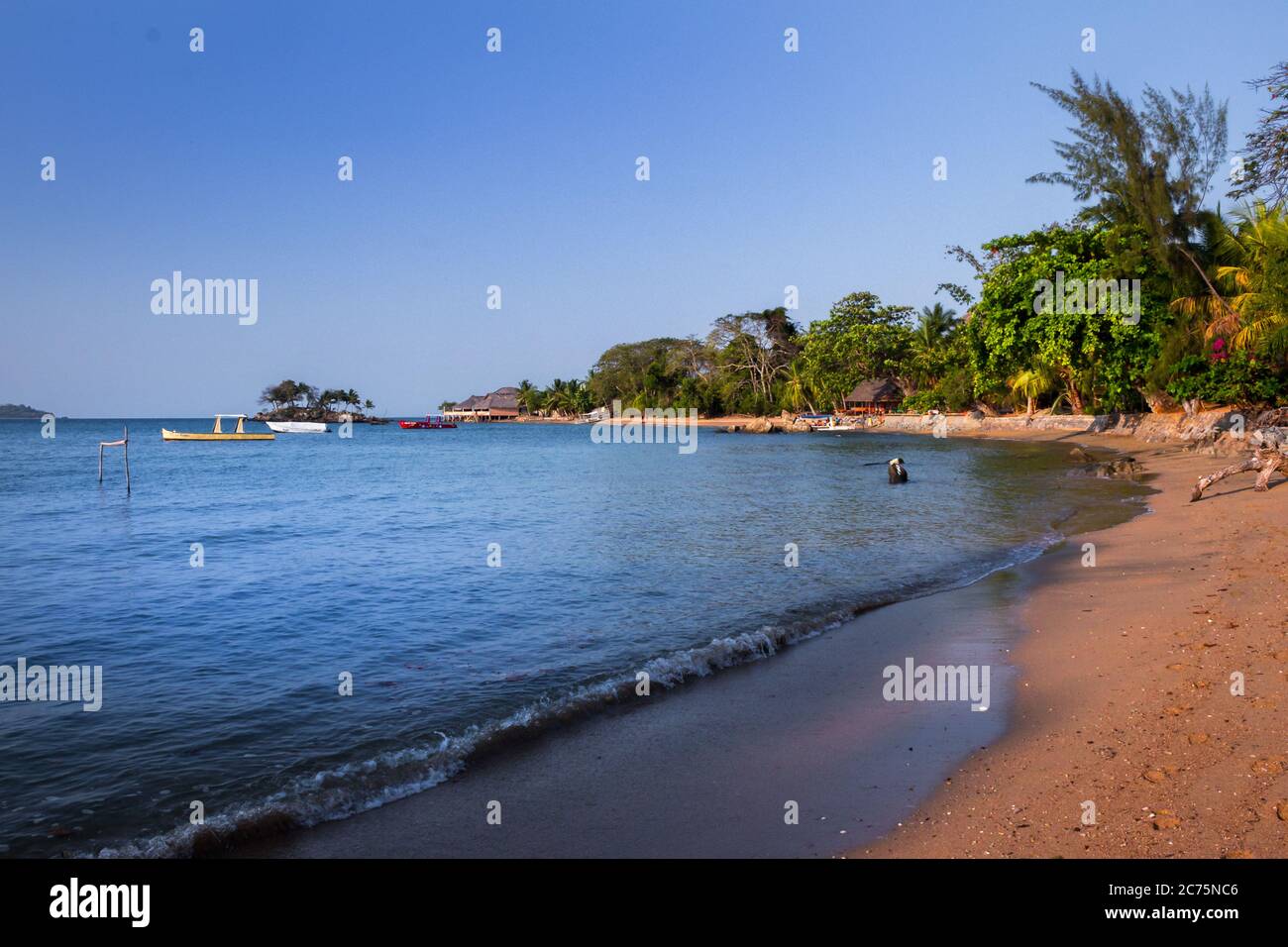 View of the Madagascar Island coastline, lined trees and boats floating ...