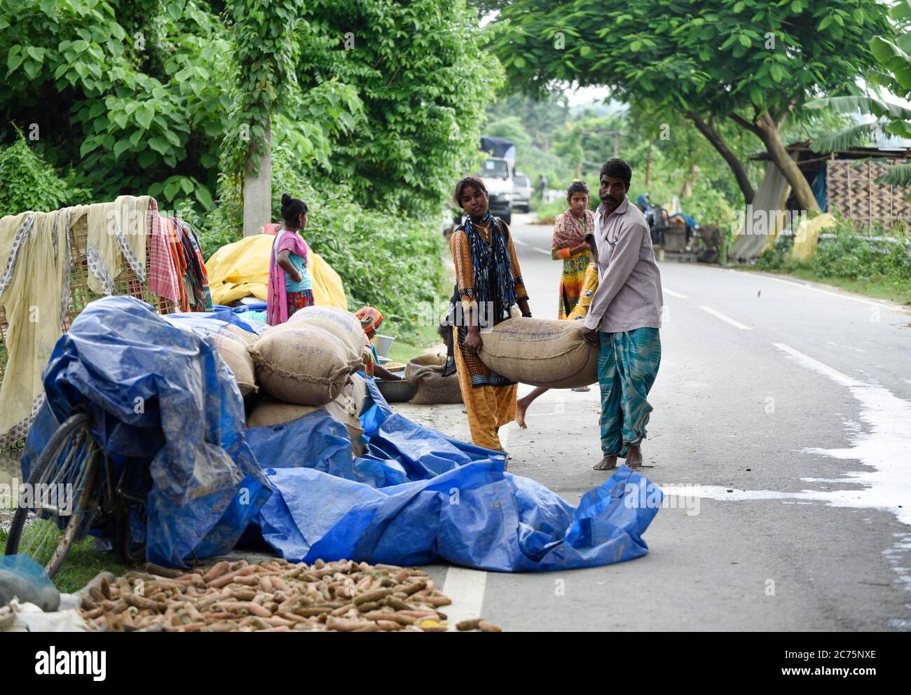 Kamrup, India. 14th July, 2020. People carry essentials to safer place ...
