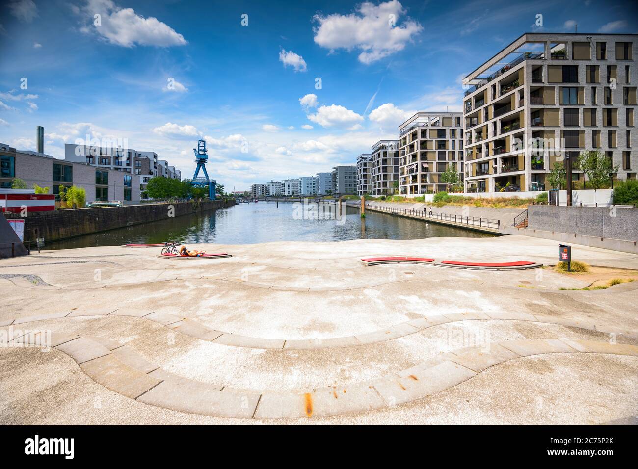 Offenbach, Germany. 14th July, 2020. A man lies on a bench at the dock ...