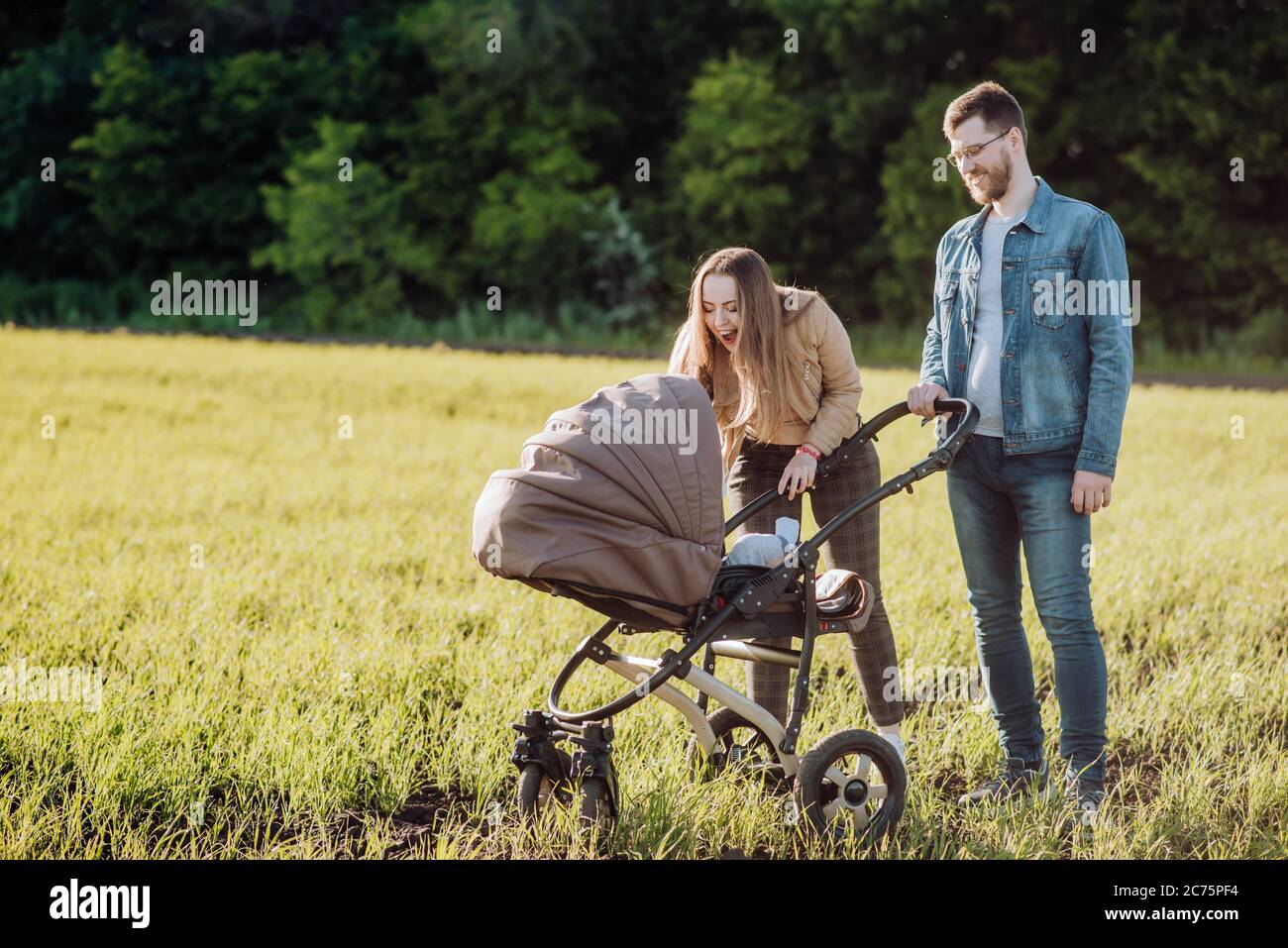 Happy family with a pram spends time outdoors Stock Photo - Alamy