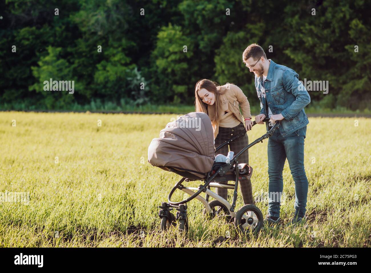 Happy family with a pram spends time outdoors Stock Photo - Alamy