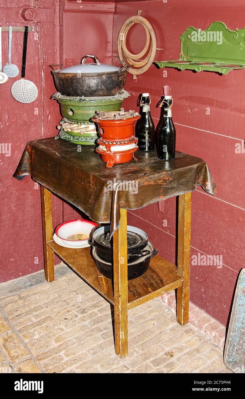 cooking area inside old windmill, 1740, dark red walls, brick floor ...