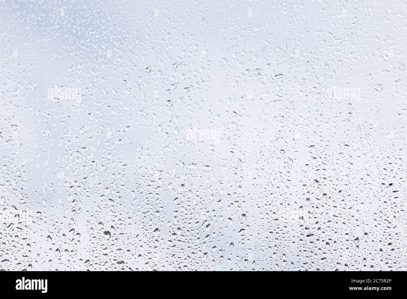 Rain drops on window glasses surface with cloudy background . Natural ...