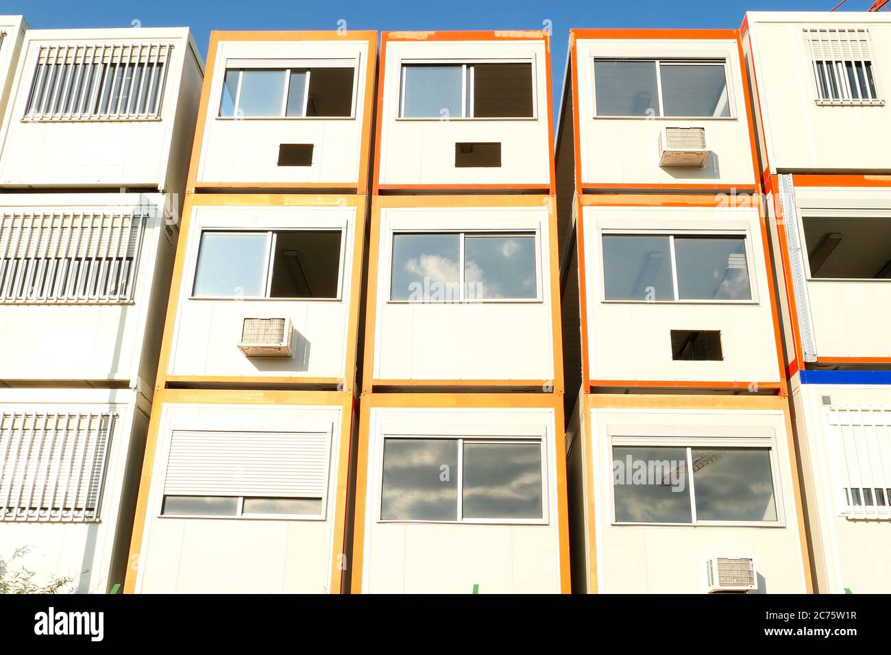 Prefabricated modular offices. Stacking of boxes for construction site ...