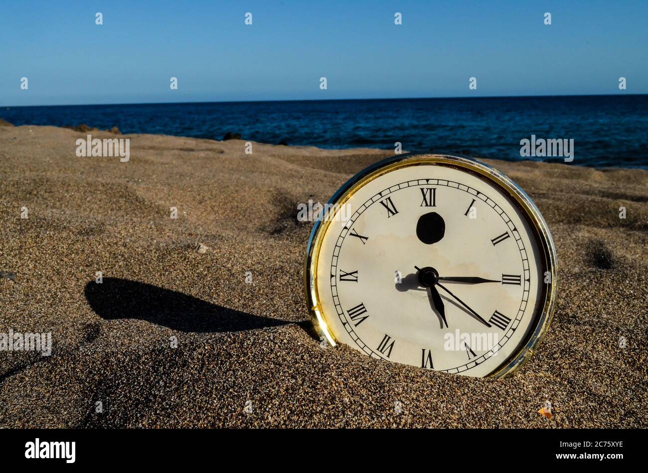 Photo Picture of a Clock on the Sand Beach Stock Photo - Alamy
