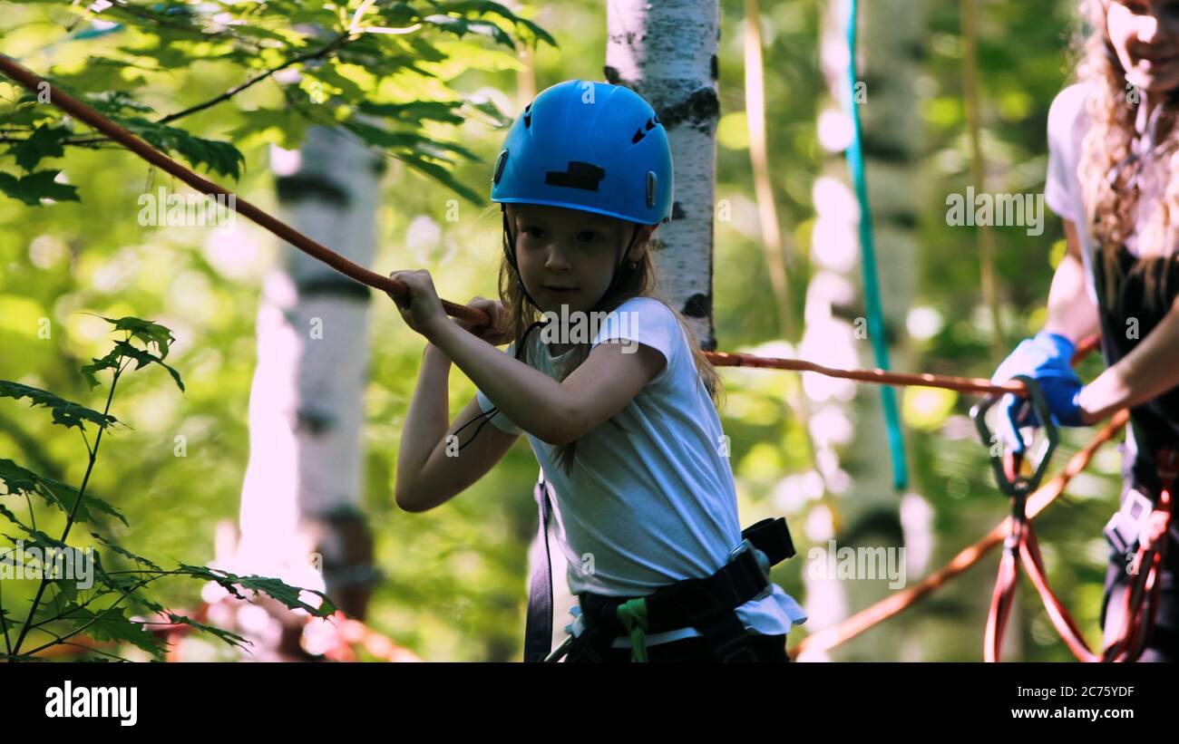 Rope adventure - a girl with an insurance hook attached to the rope ...