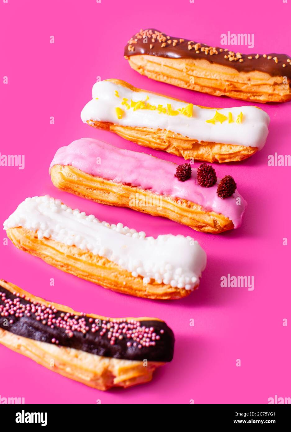 The set of colorful and delicious eclairs with many flavors Stock Photo ...