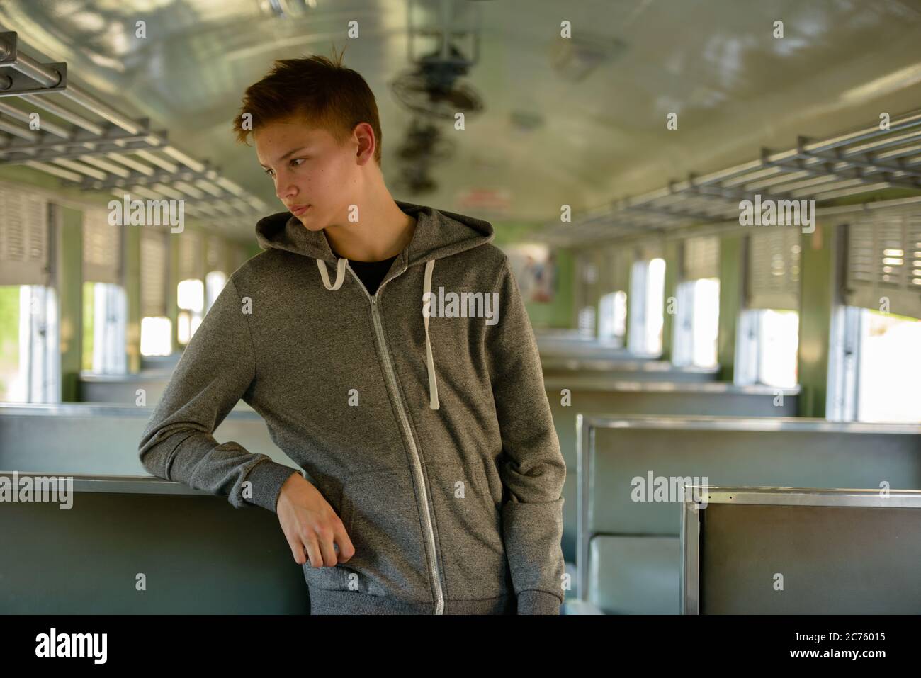 Young handsome teenage boy at the railway train station Stock Photo - Alamy