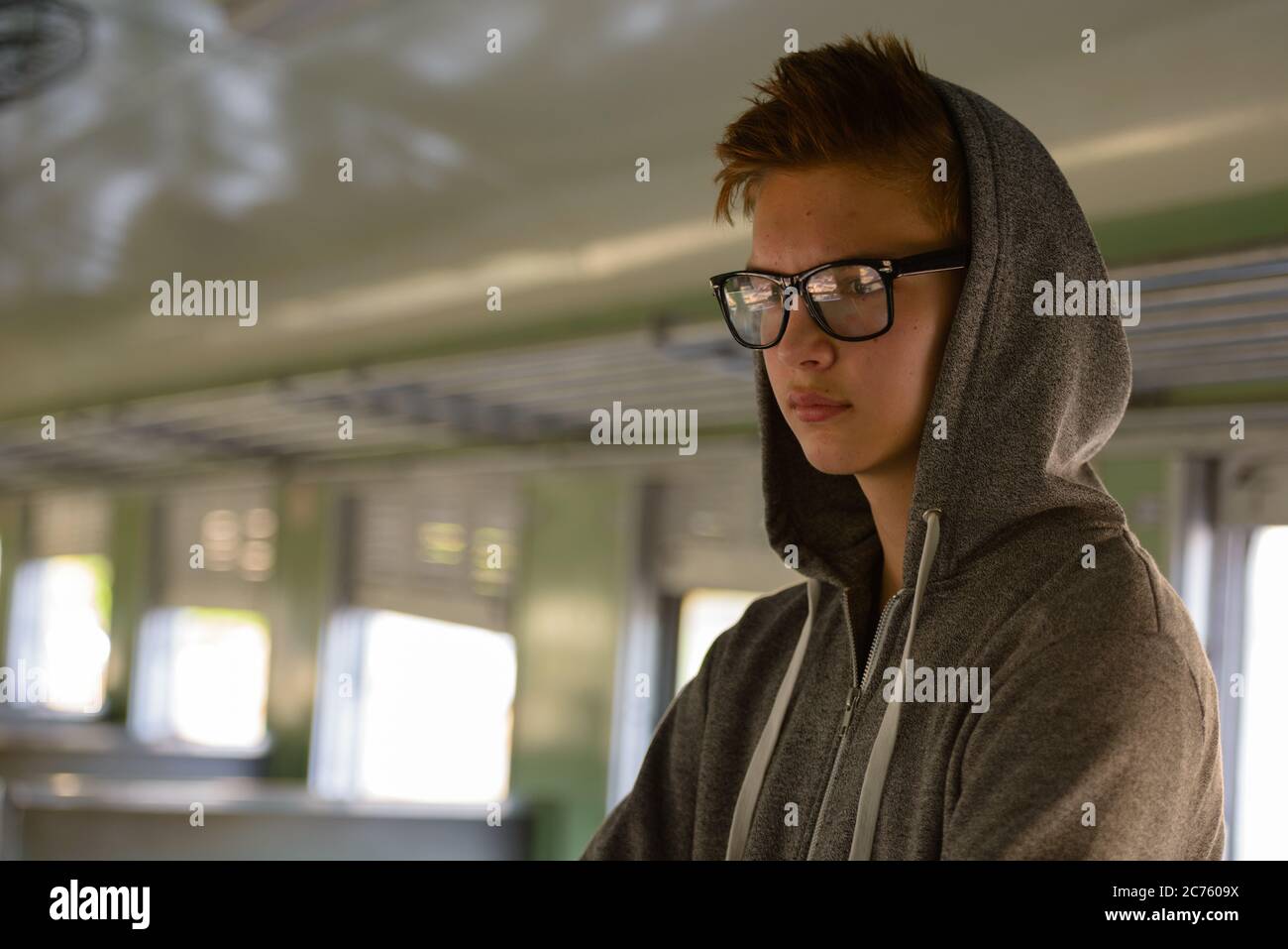 Young handsome teenage boy at the railway train station Stock Photo - Alamy