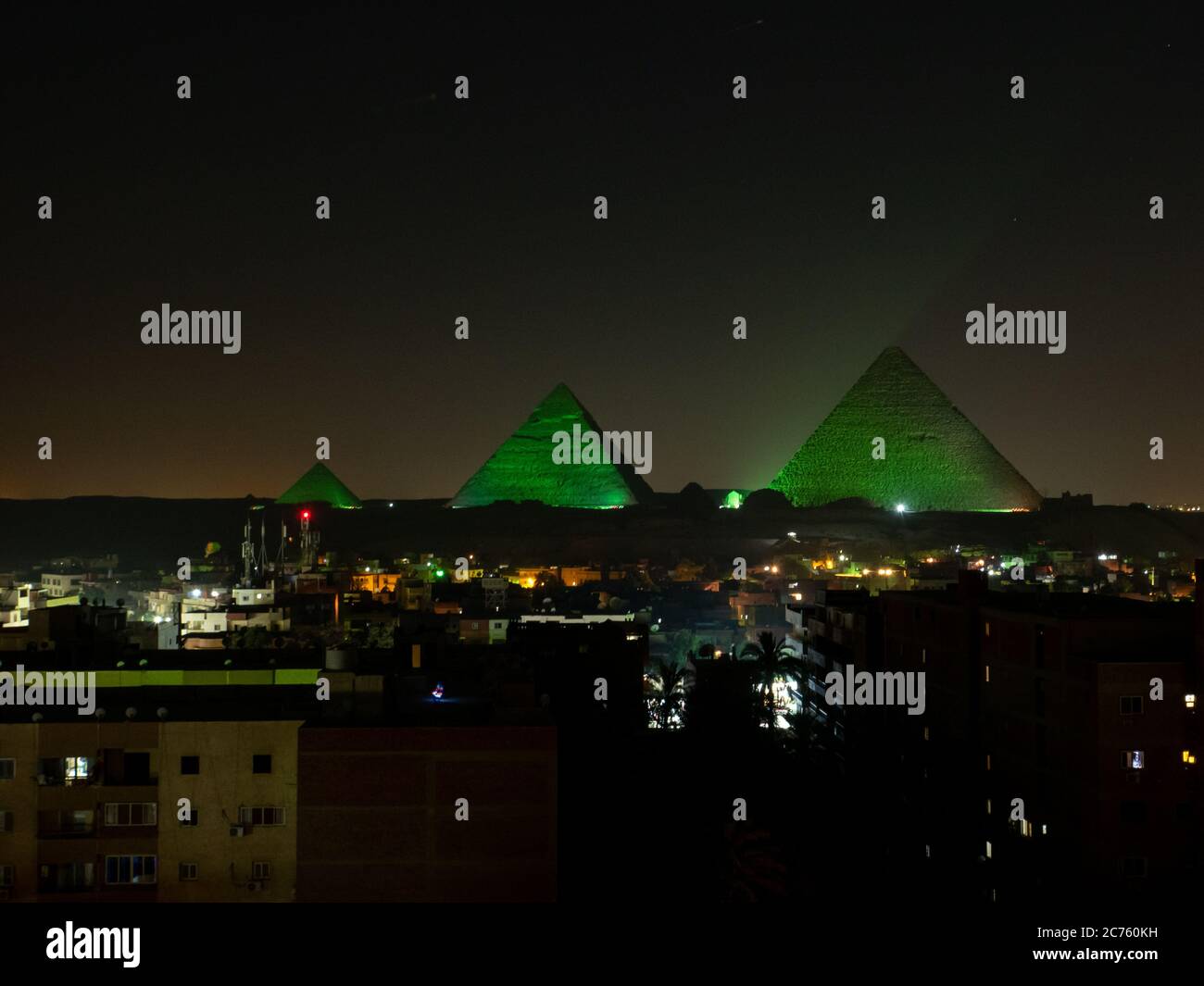 pyramids with skyline of giza at night with illustration lightshow ...
