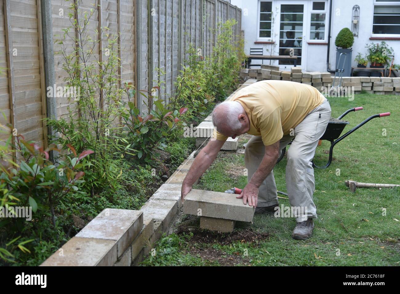 Older caucasian man performing brick laying Stock Photo - Alamy