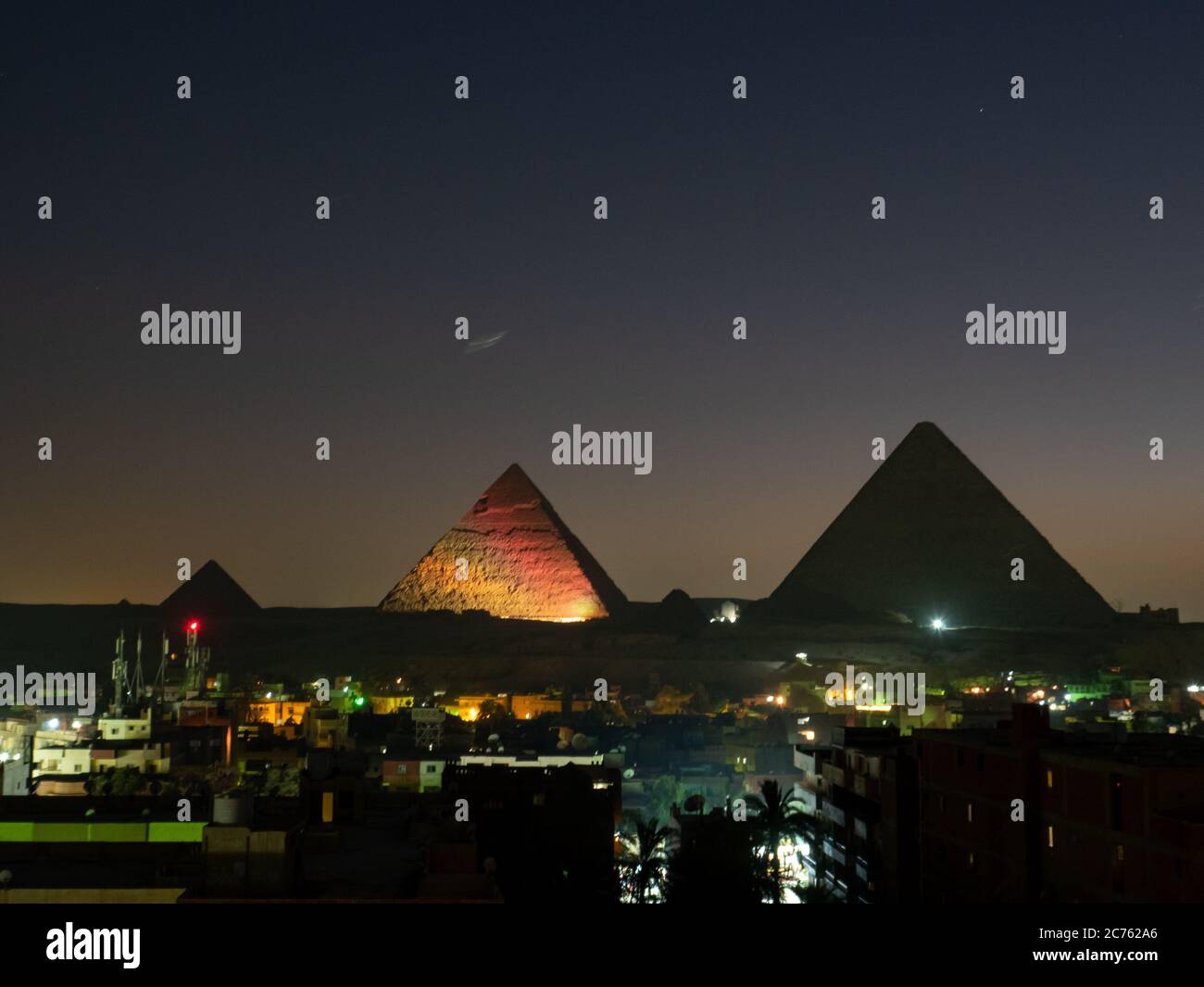 pyramids with skyline of giza at night with illustration lightshow ...