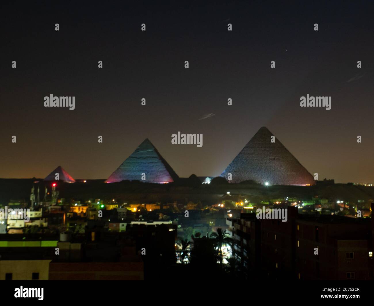 pyramids with skyline of giza at night with illustration lightshow ...