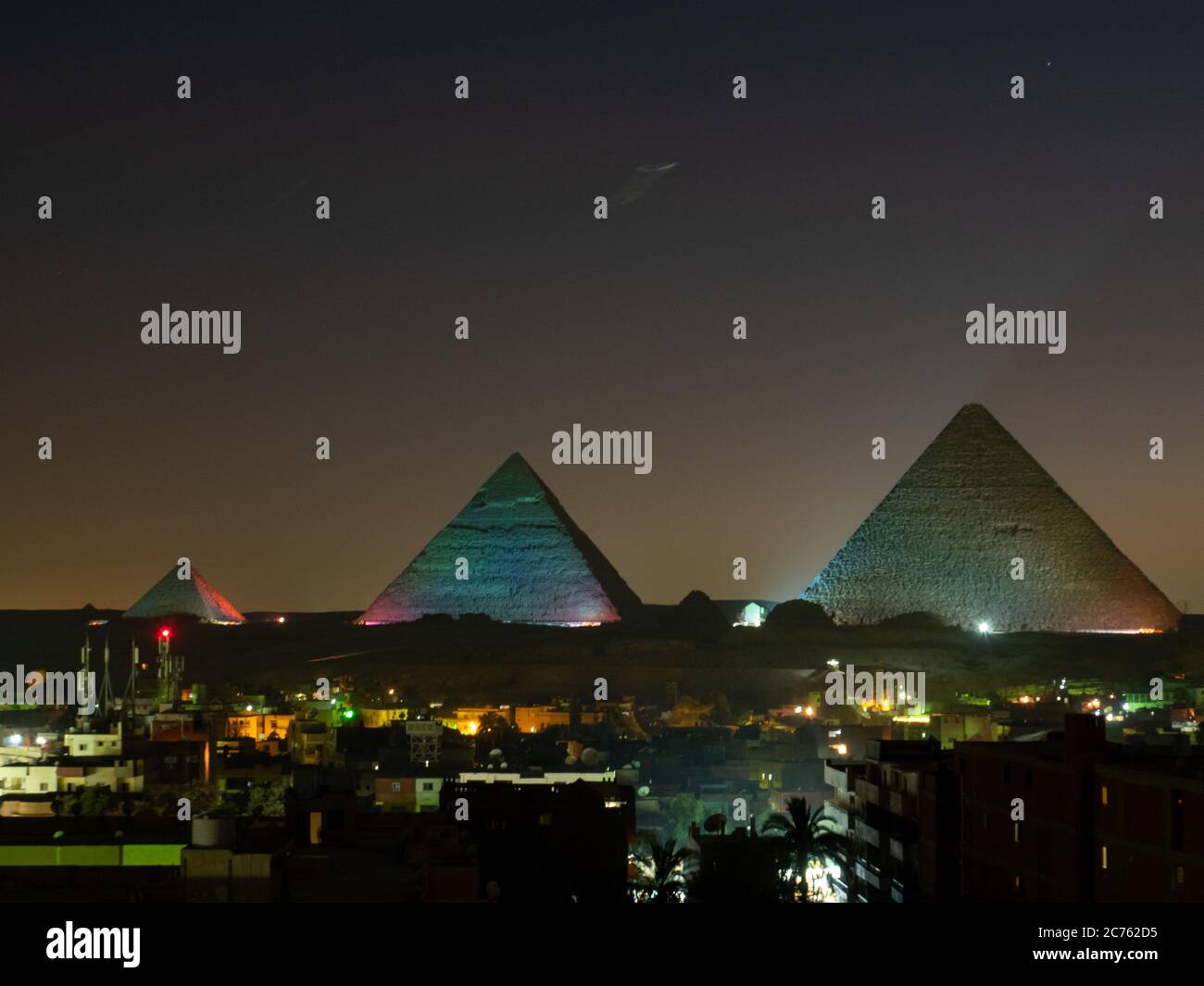 pyramids with skyline of giza at night with illustration lightshow ...