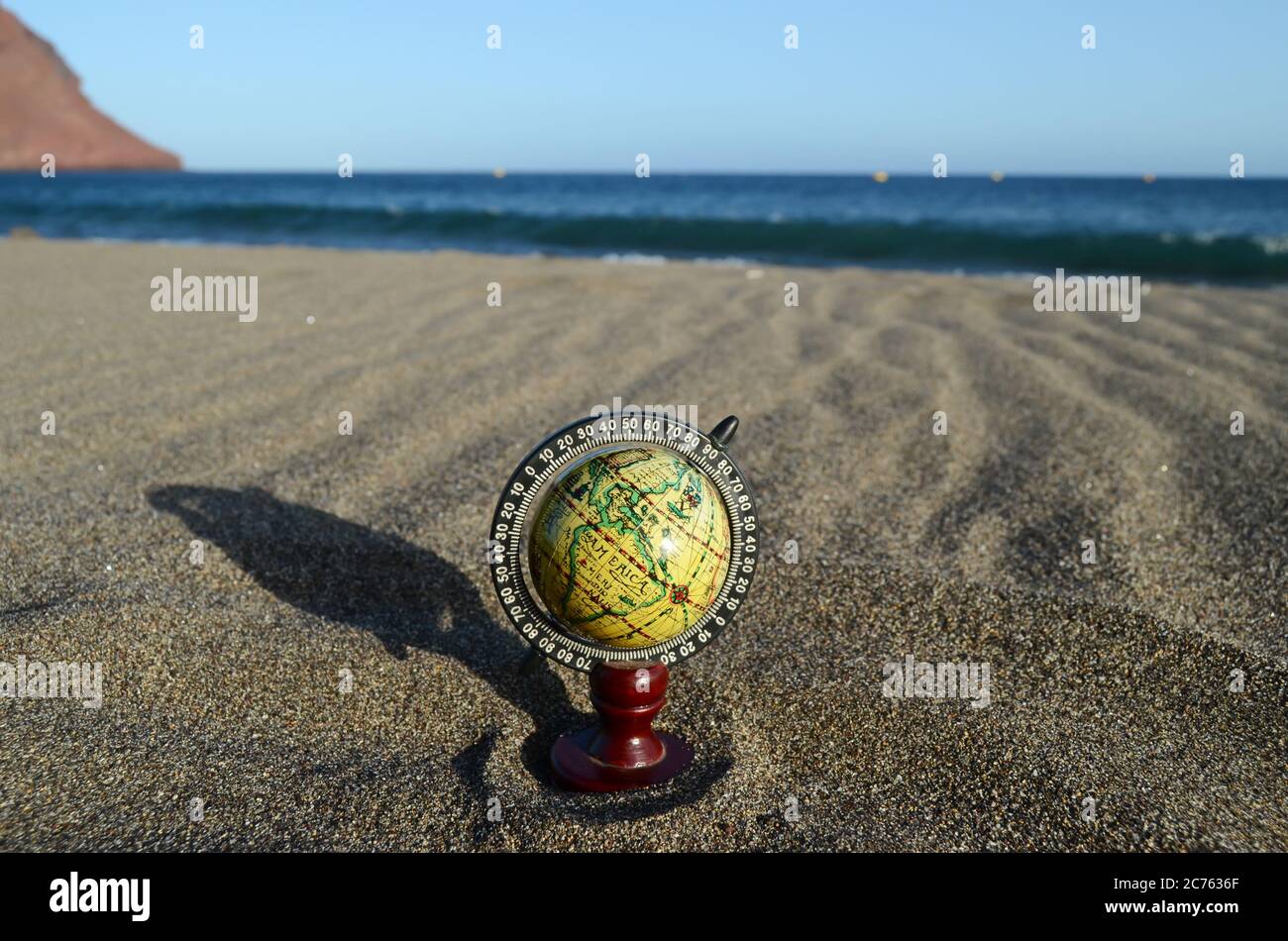 Globe Earth on the Beach near Ocean Stock Photo - Alamy
