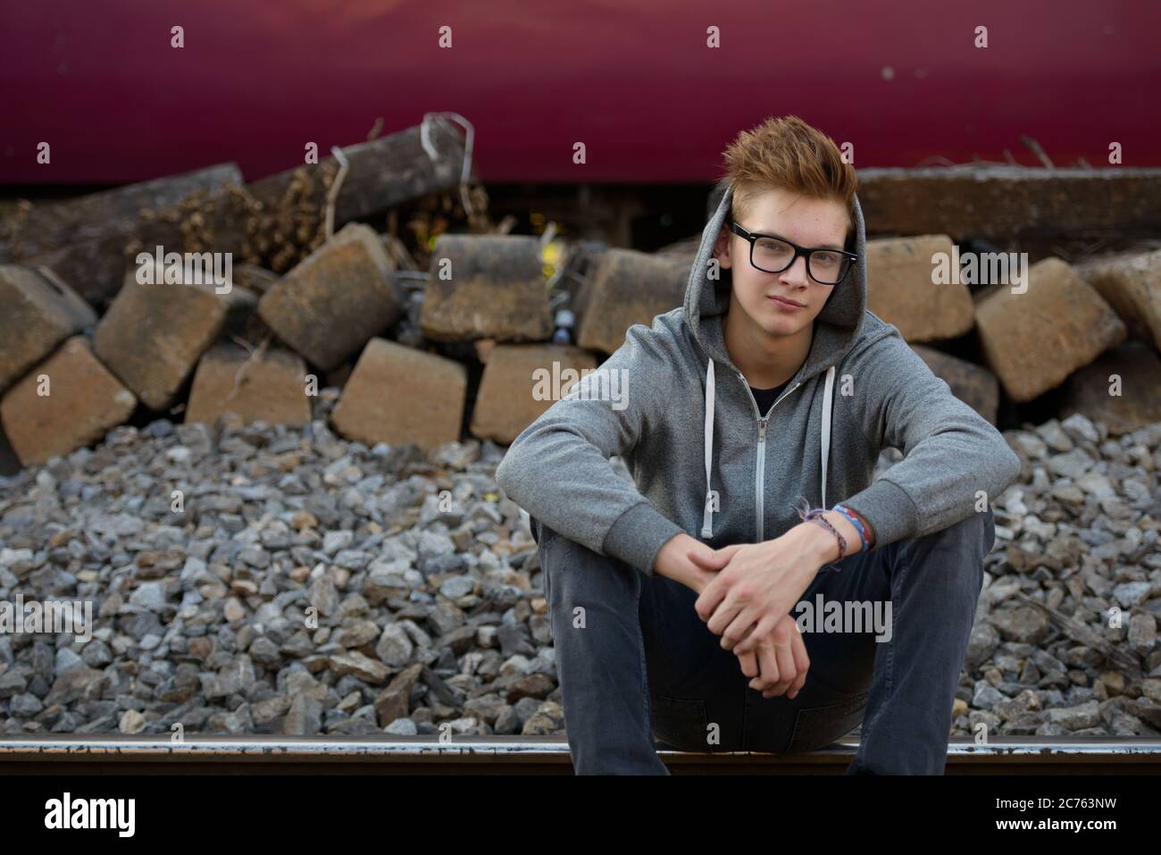 Young handsome teenage boy at the railway train station Stock Photo - Alamy