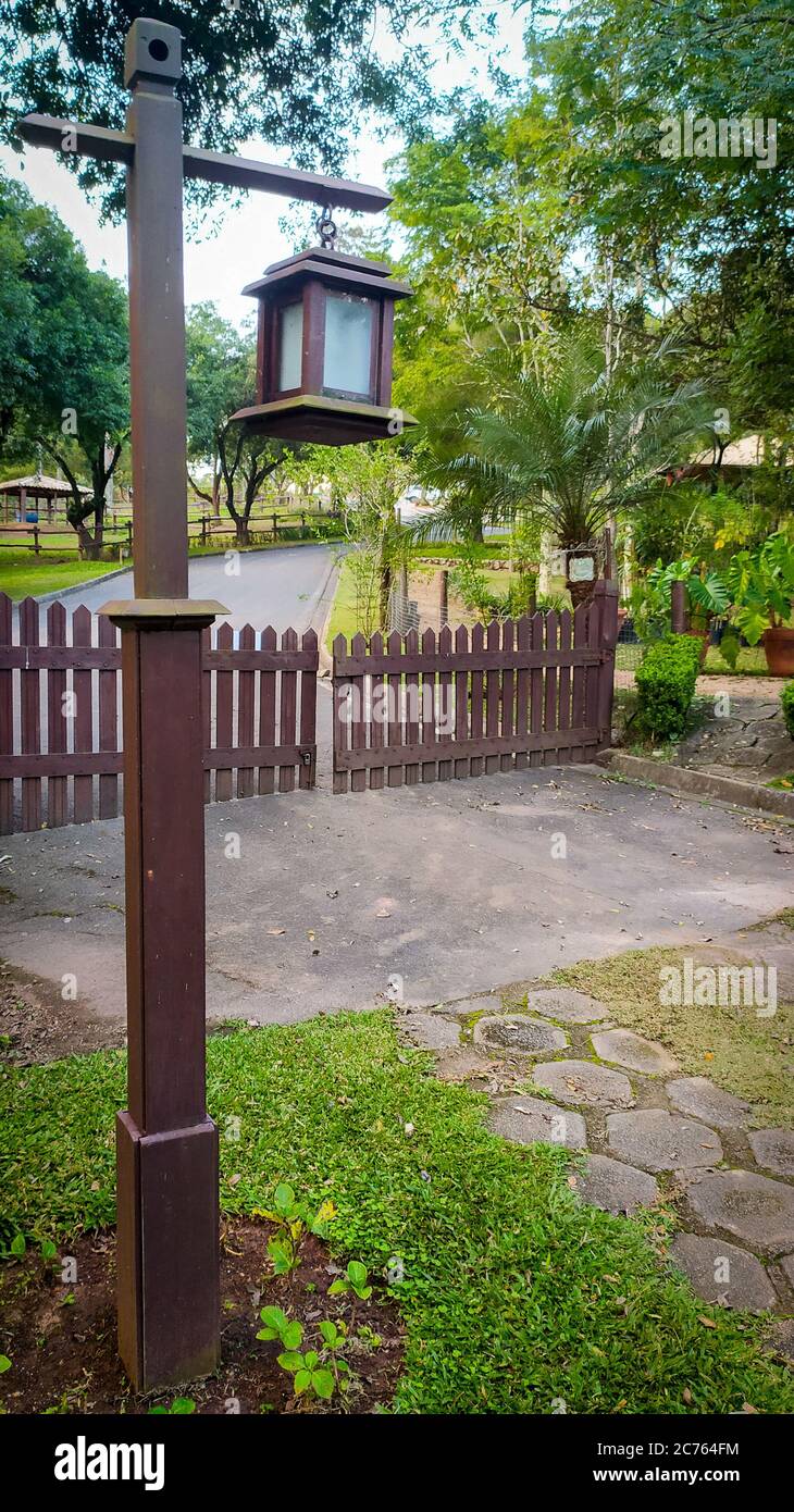 Traditional old lamp against a a idyllic scnene in nature. Wood poste ...