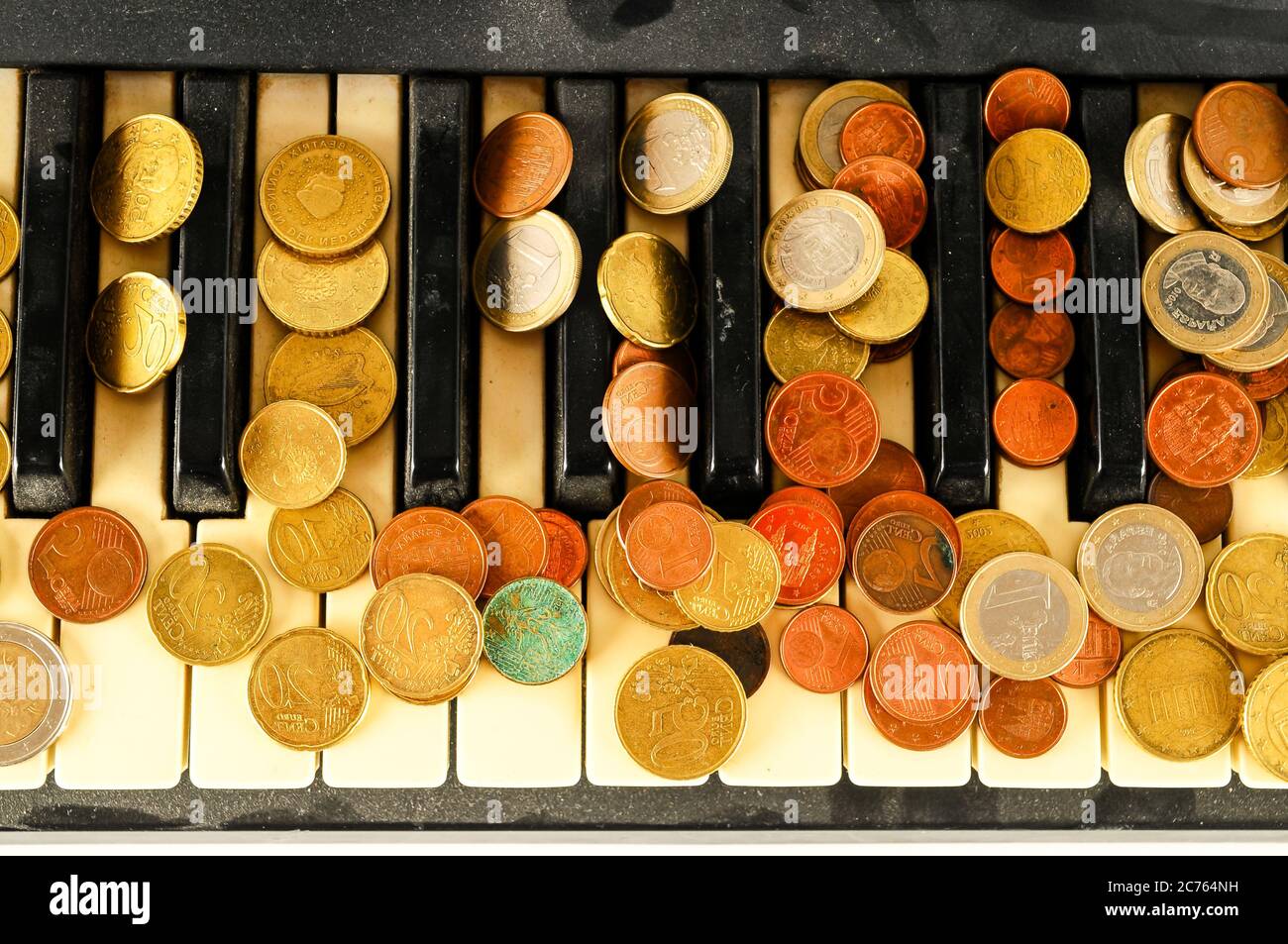 Photo picture close-up of piano keys keyboard and coin money Stock ...