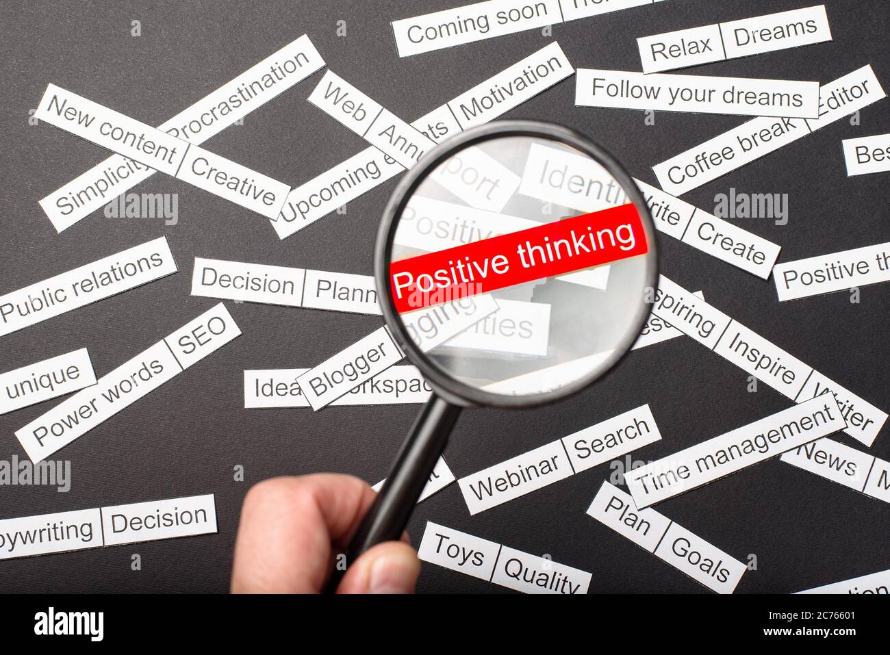 Magnifier glass over the red inscription Positive thinking cut out of ...