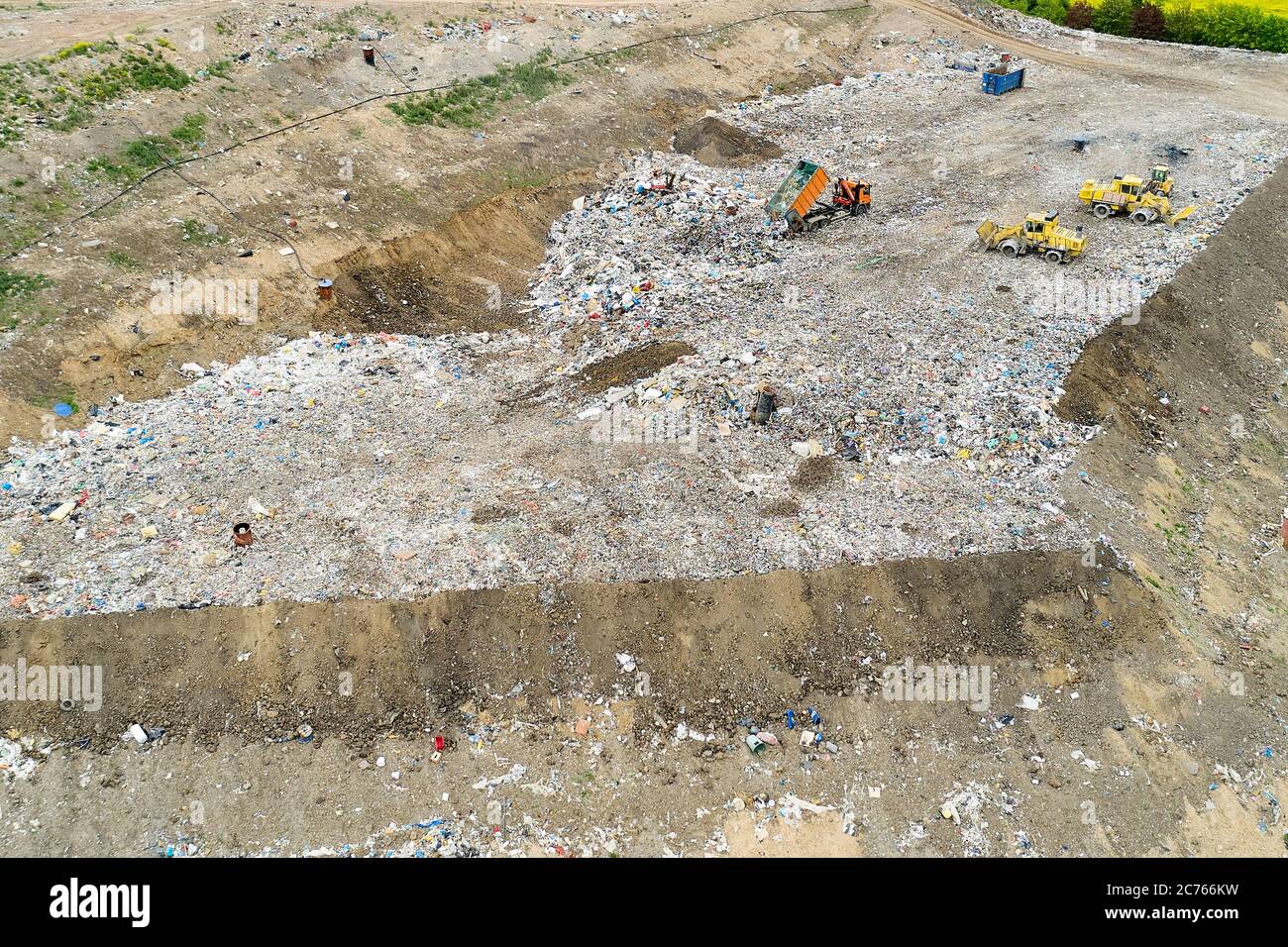 Garbage pile in trash dump or landfill. Dump trucks and excavators ...